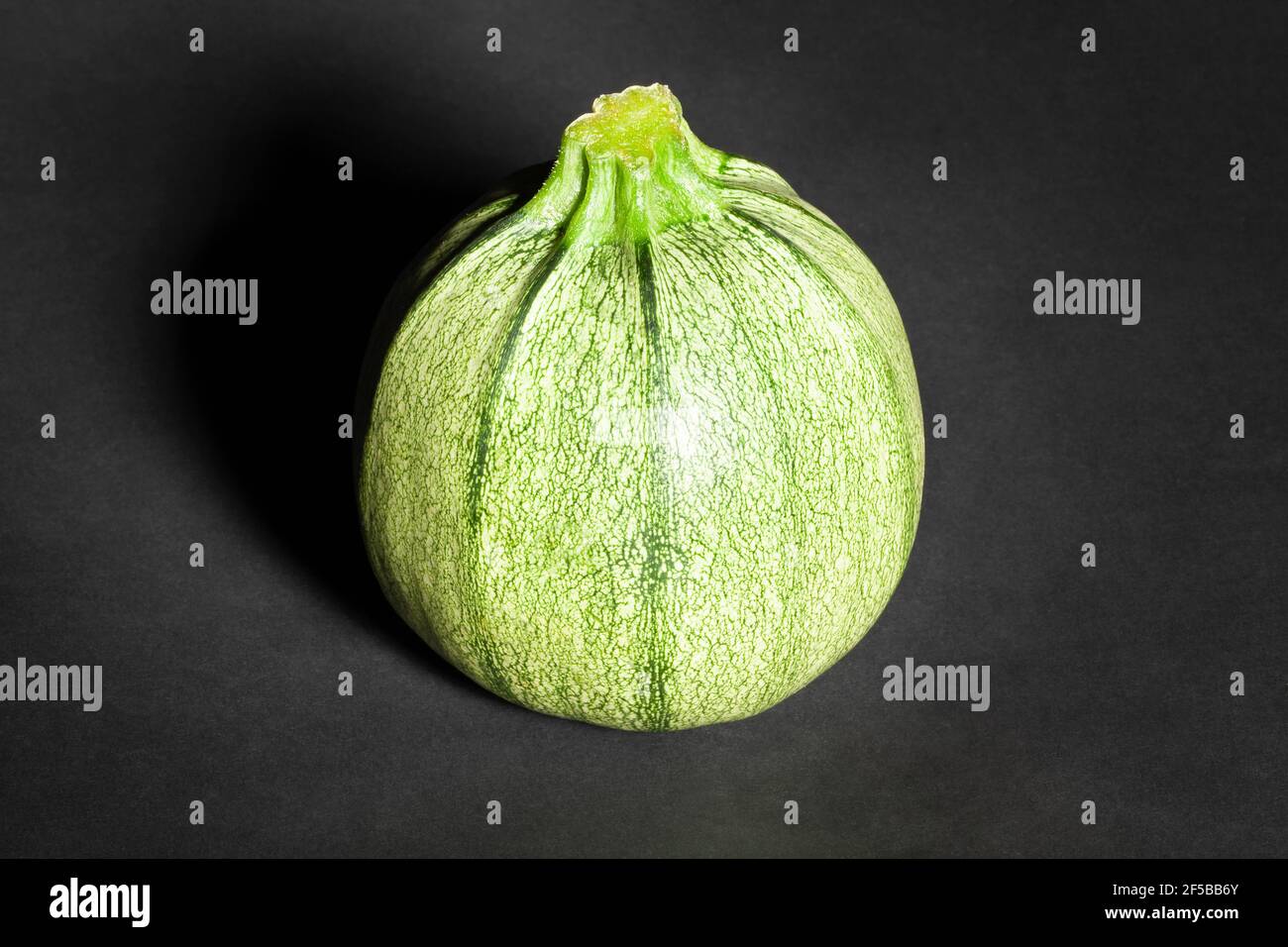 round squash on black background Stock Photo - Alamy