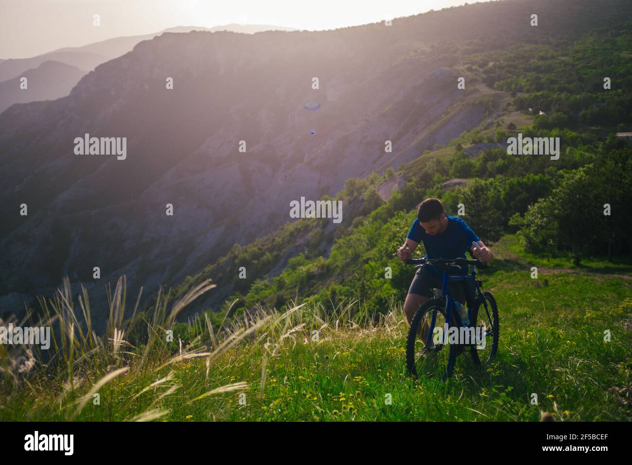 Downhill rider pushing bike hi-res stock photography and images - Alamy