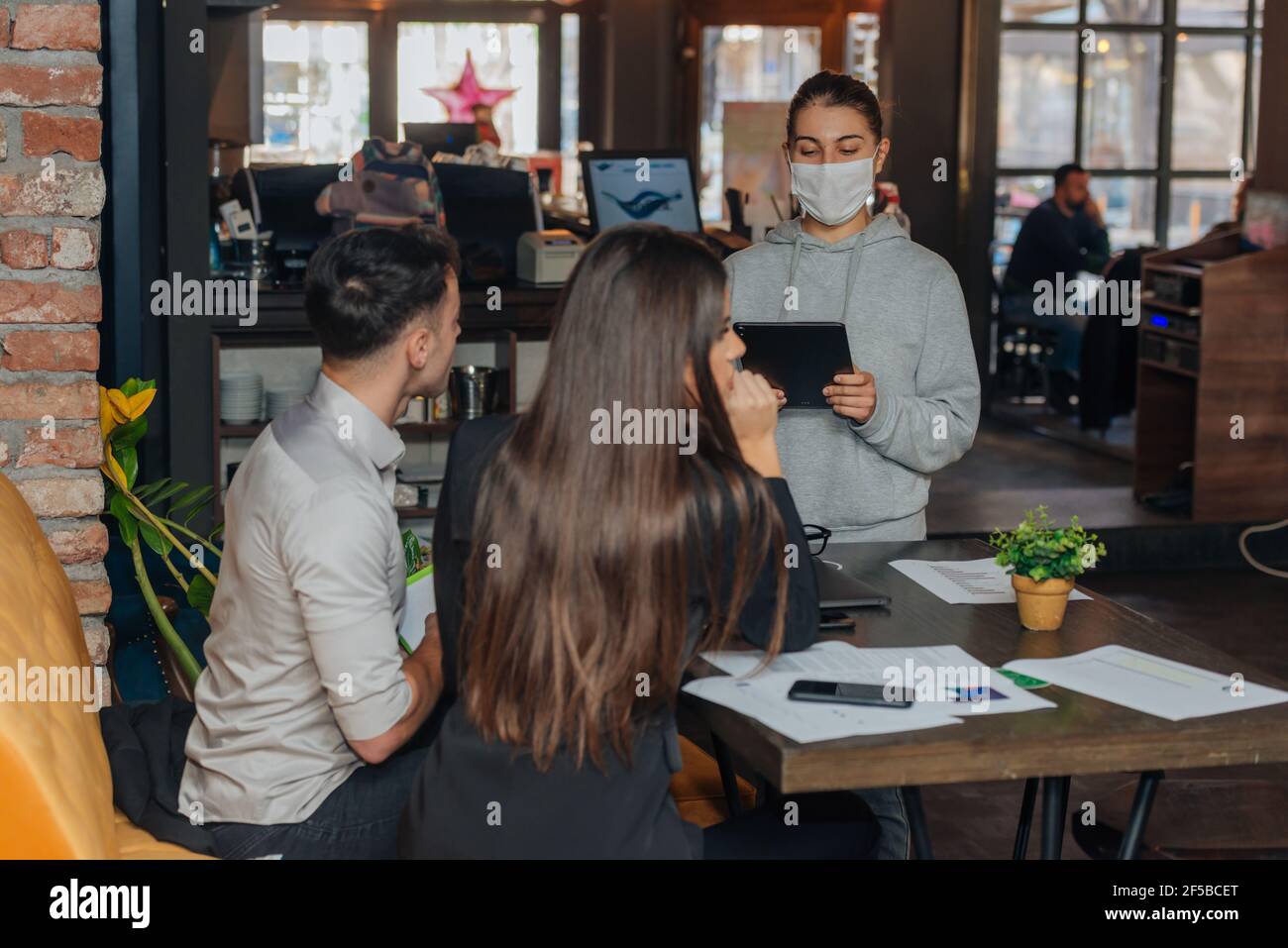 Successful young business people sharing ideas and smiling while ...