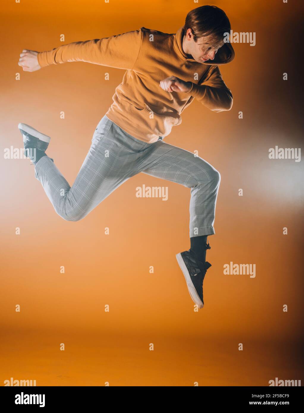 Muscular young guy practicing modern style dance poses Stock Photo - Alamy