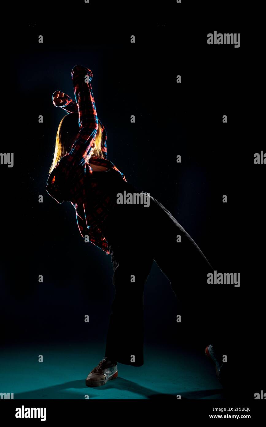 Flexible young silhouette dancer performing a stylish dance movement ...