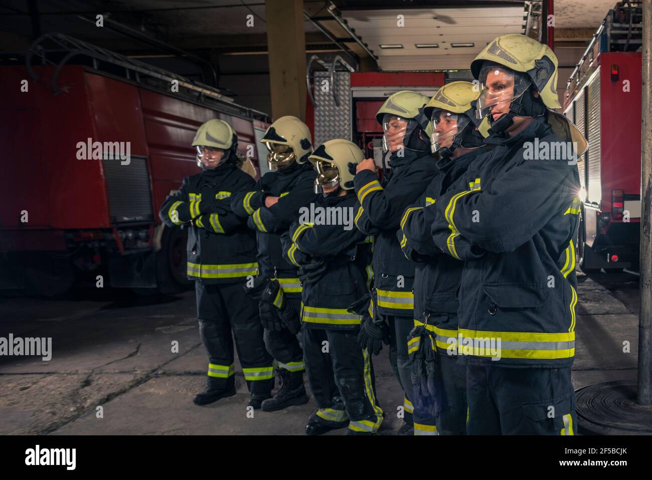Group of firefighters standing confident with arms crossed. Firemen ...