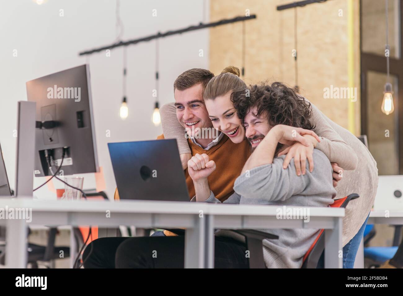 Group of coworkers, colleagues having fun at the office while chatting ...