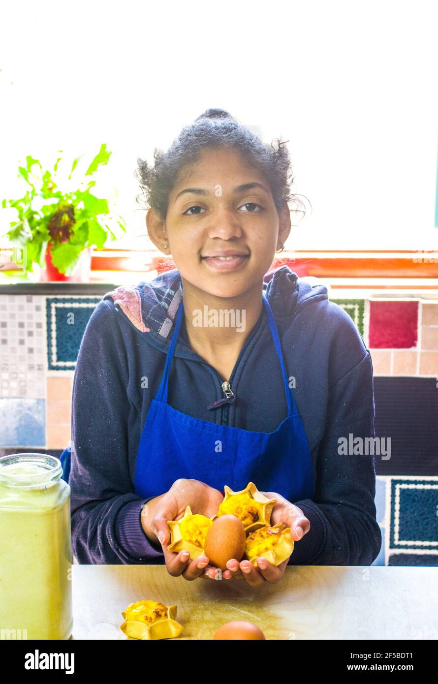 young girl cook cooks delicious pastries made with fresh eggs, ricotta ...