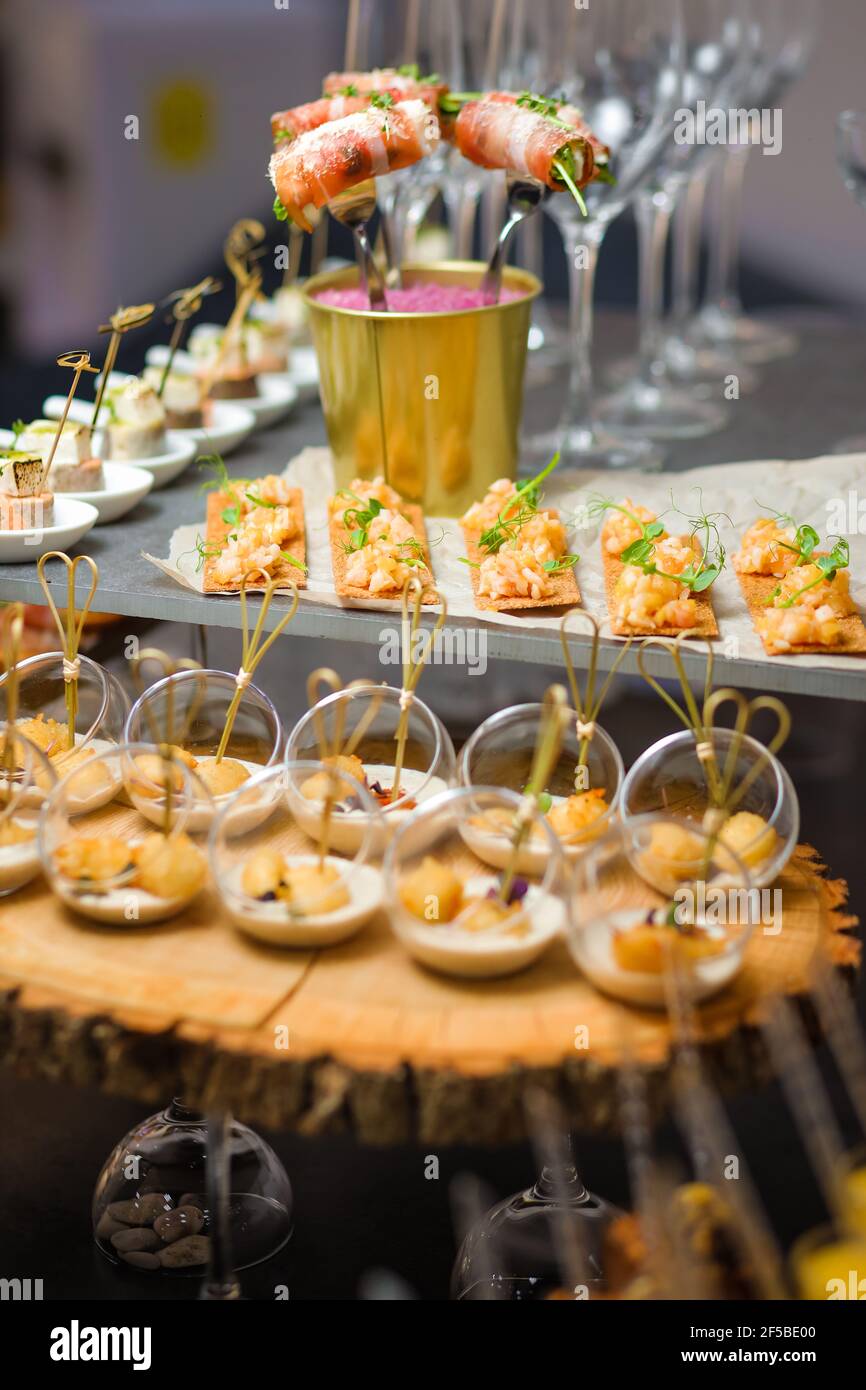 Catering service. Table with snacks food at event Stock Photo - Alamy