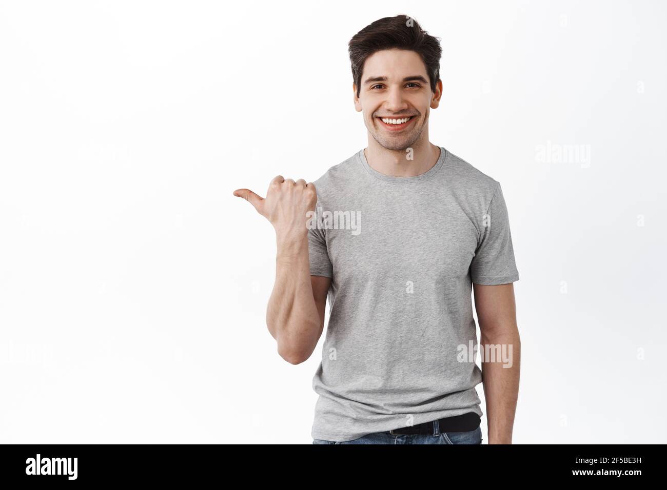 Handsome caucasian man inviting check out store, pointing left aside ...