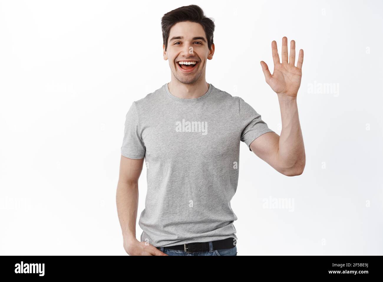 Hello. Friendly handsome man waving at you, welcoming gesture, saying ...