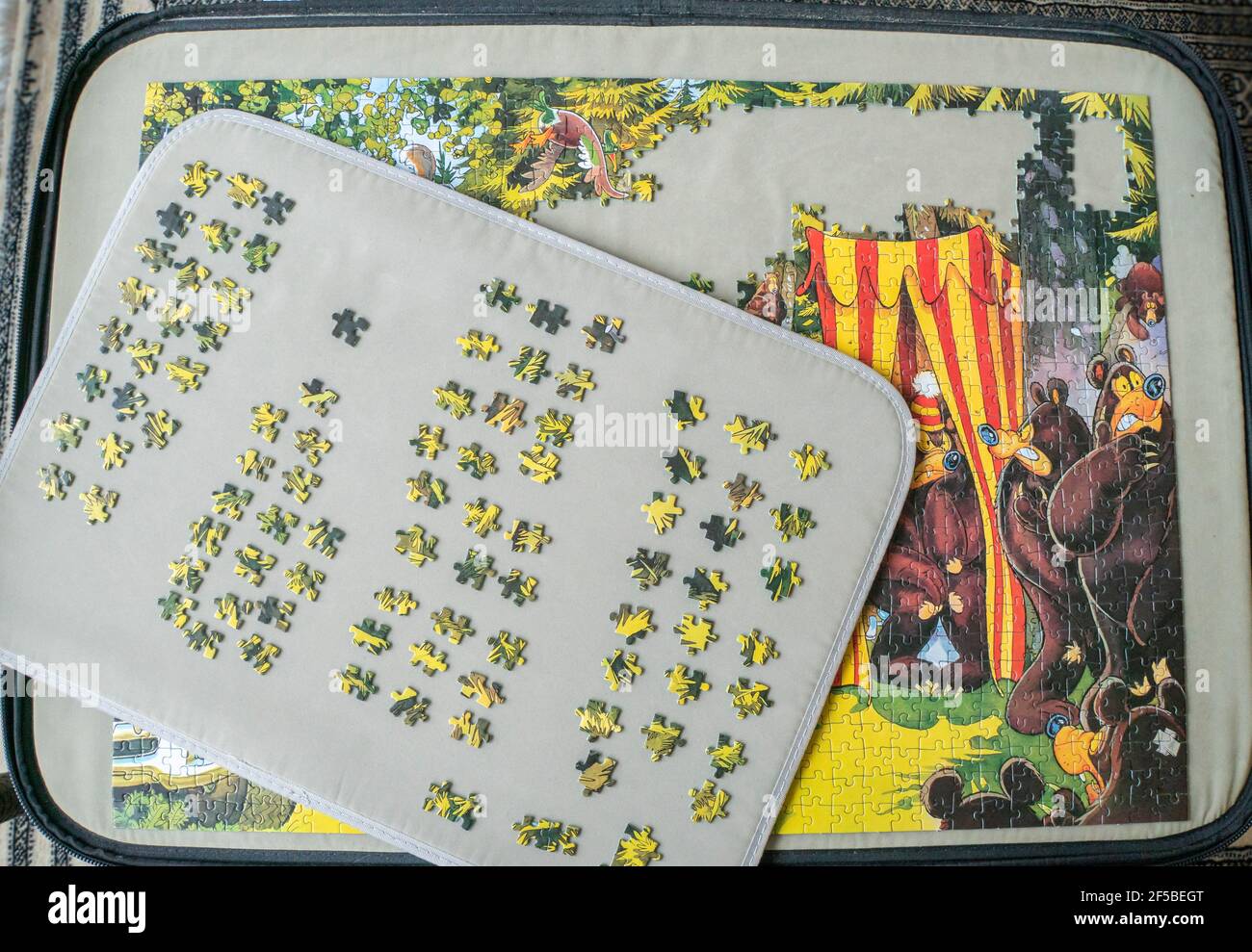 A partially completed jigsaw puzzle on a board Stock Photo - Alamy