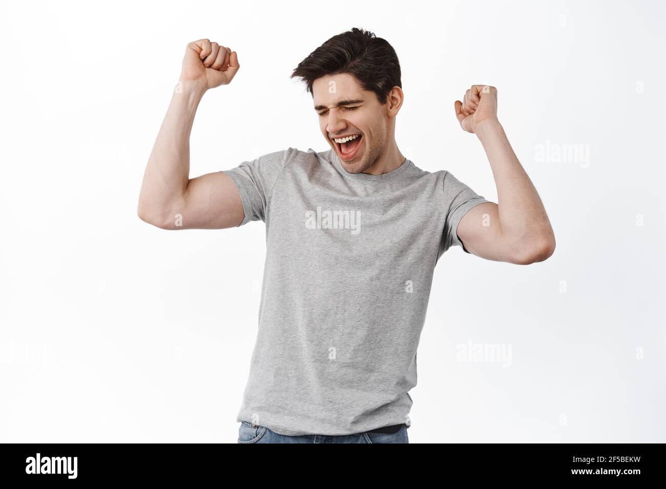 Happy man celebrating and having fun, dancing from success and ...