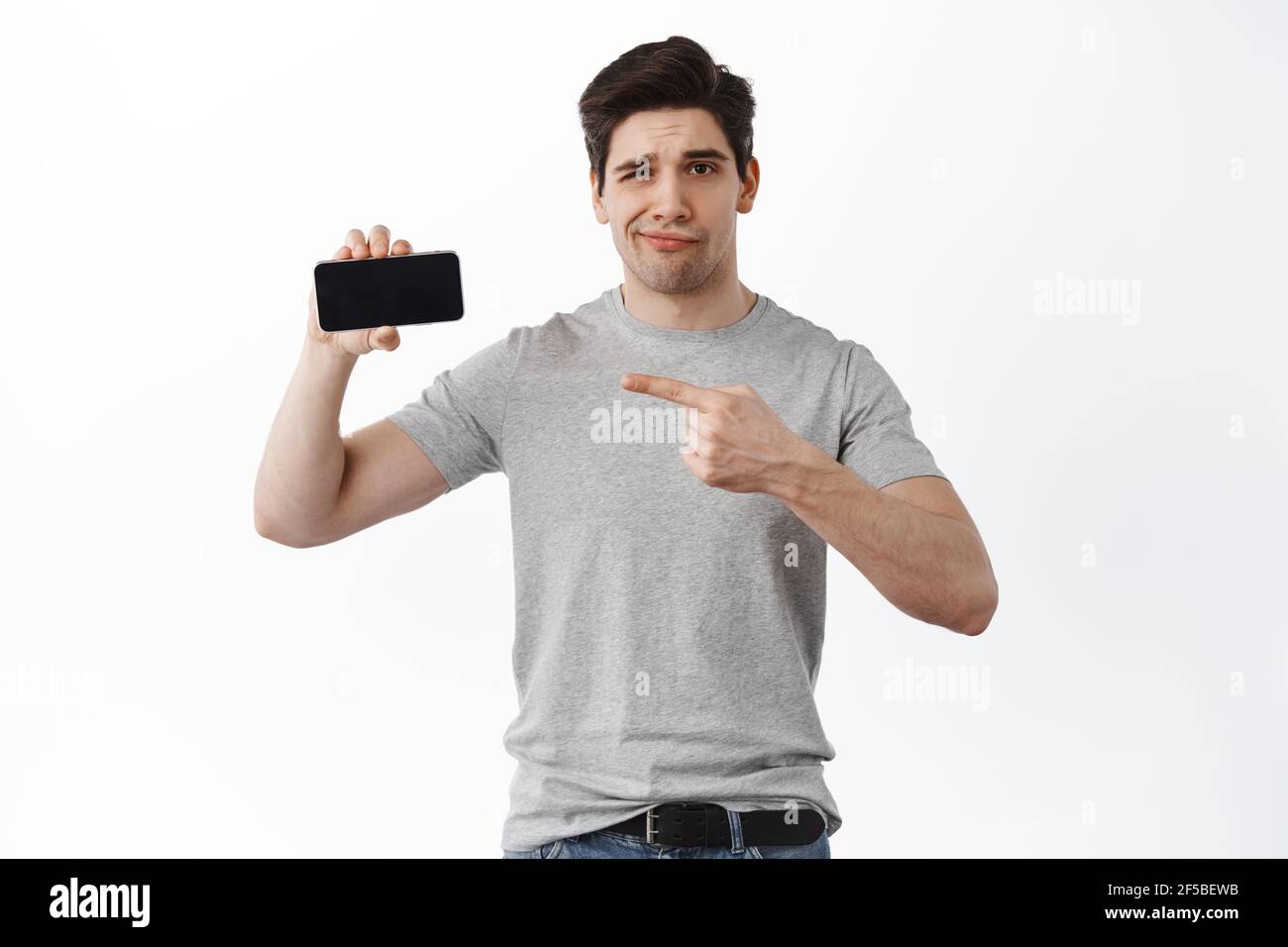 Disappointed man pointing at lame online content, showing empty ...