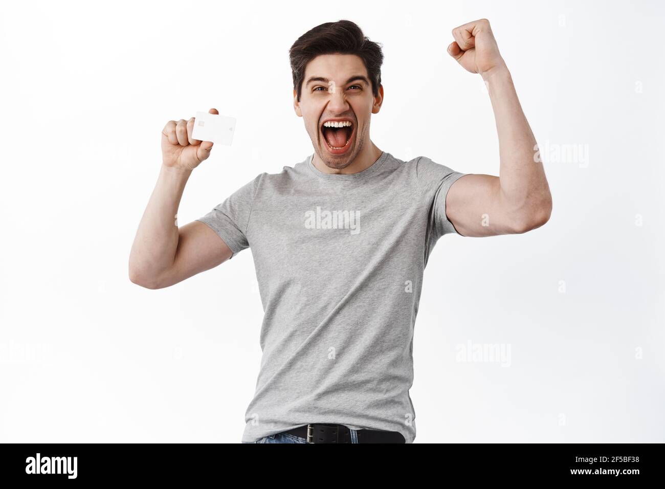 Happy man rejoicing, showing credit card and scream of joy and ...