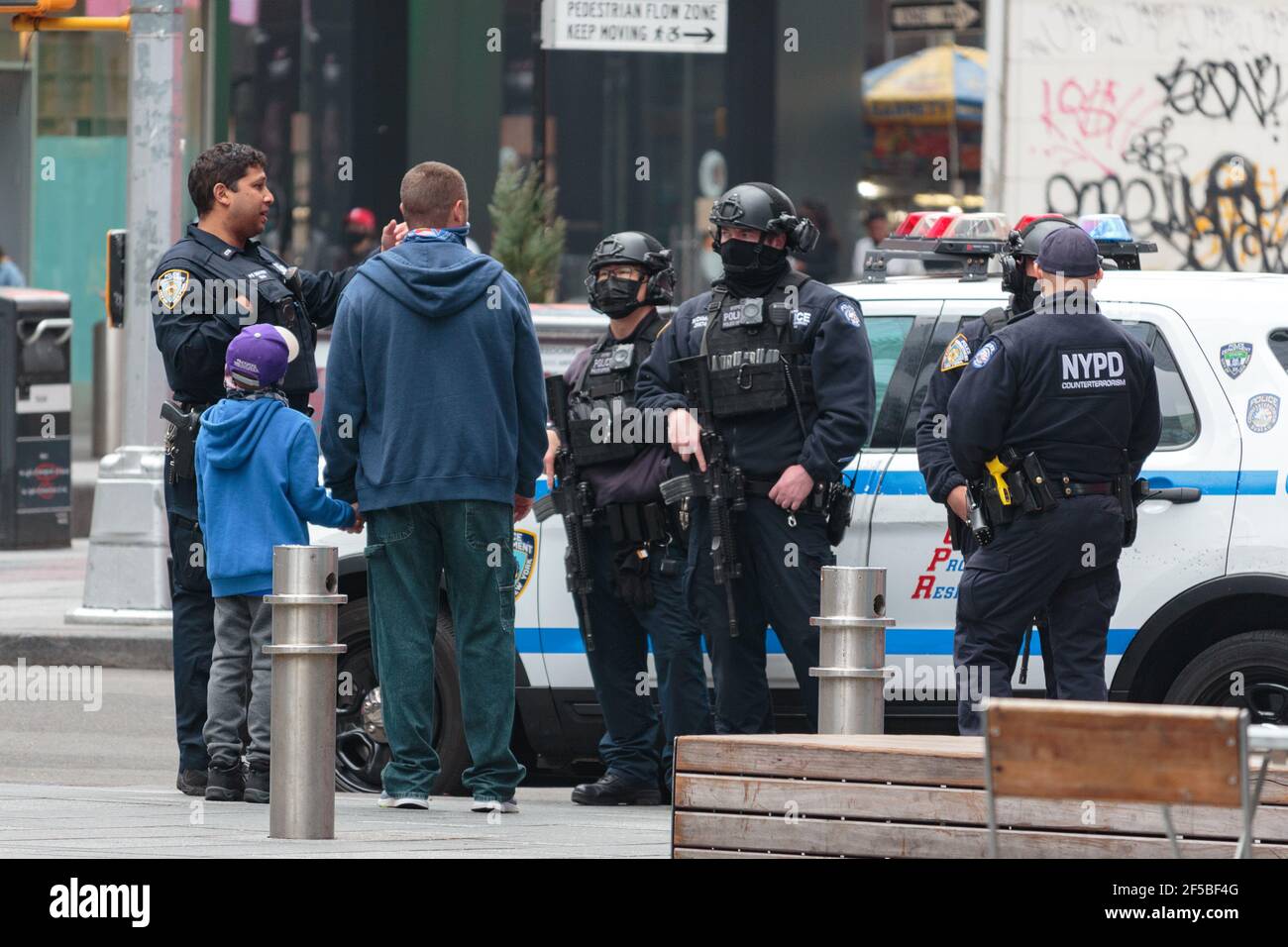 a group of NYPD cops in face masks and carrying semi-automatic guns ...
