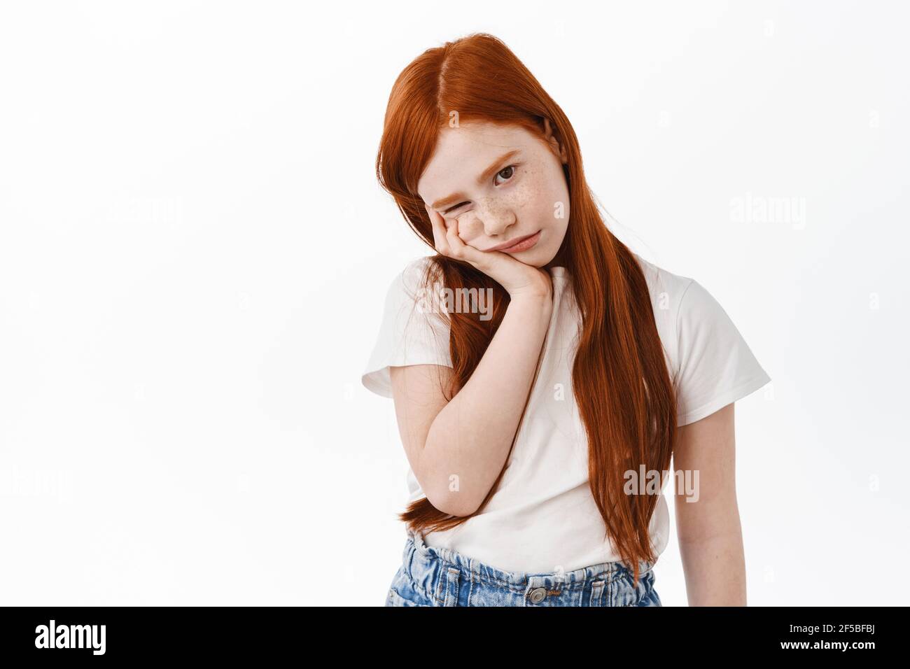 Portrait of bored cute red head little girl with freckles, face palm ...