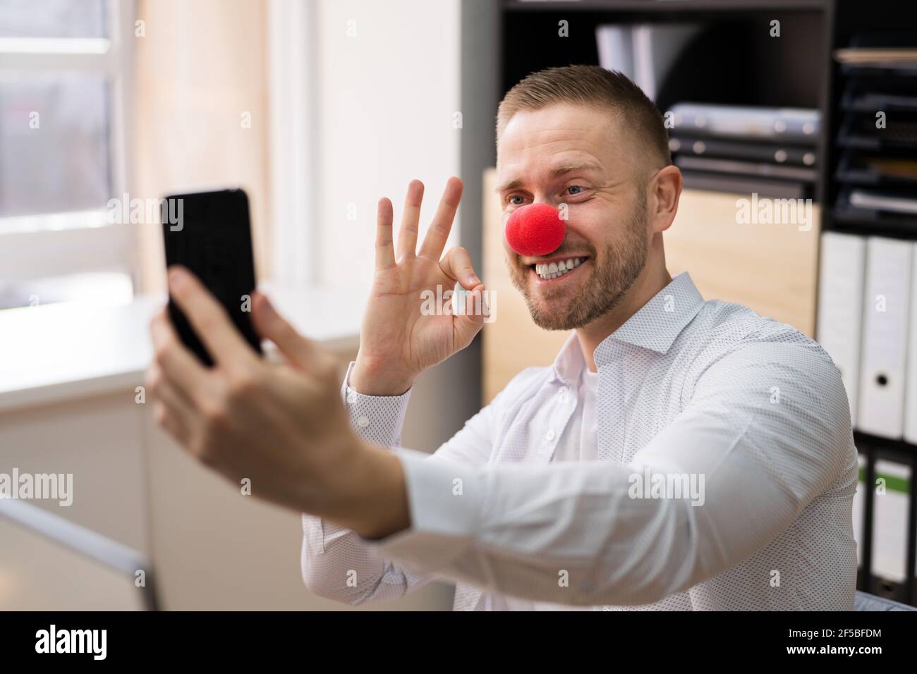 Happy Working People Using Mobile Phone In Office Stock Photo - Alamy