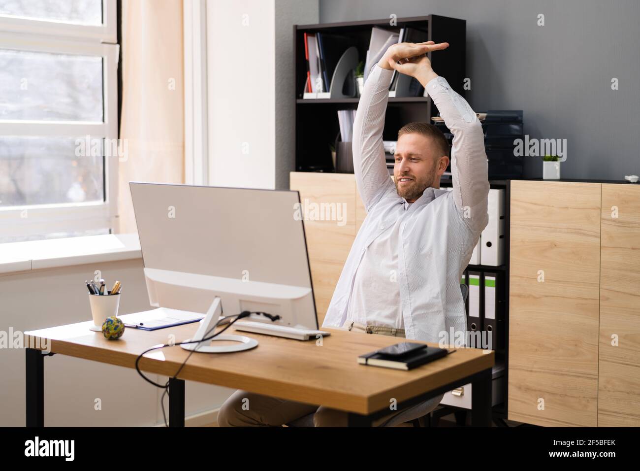 Stretch Exercise At Office Desk. Businessman At Computer Stock Photo ...