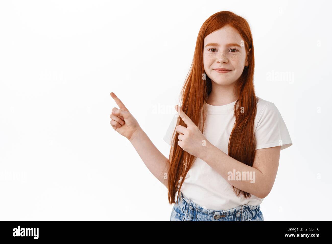 Lovely red head kid girl with freckles, ginger child pointing fingers ...
