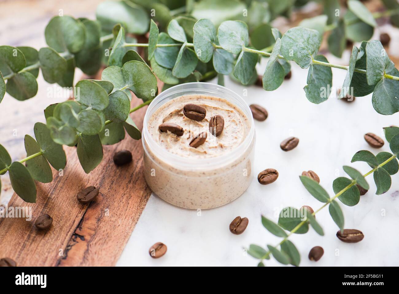 Natural body coffee scrub with eucalyptus branches on marble background ...