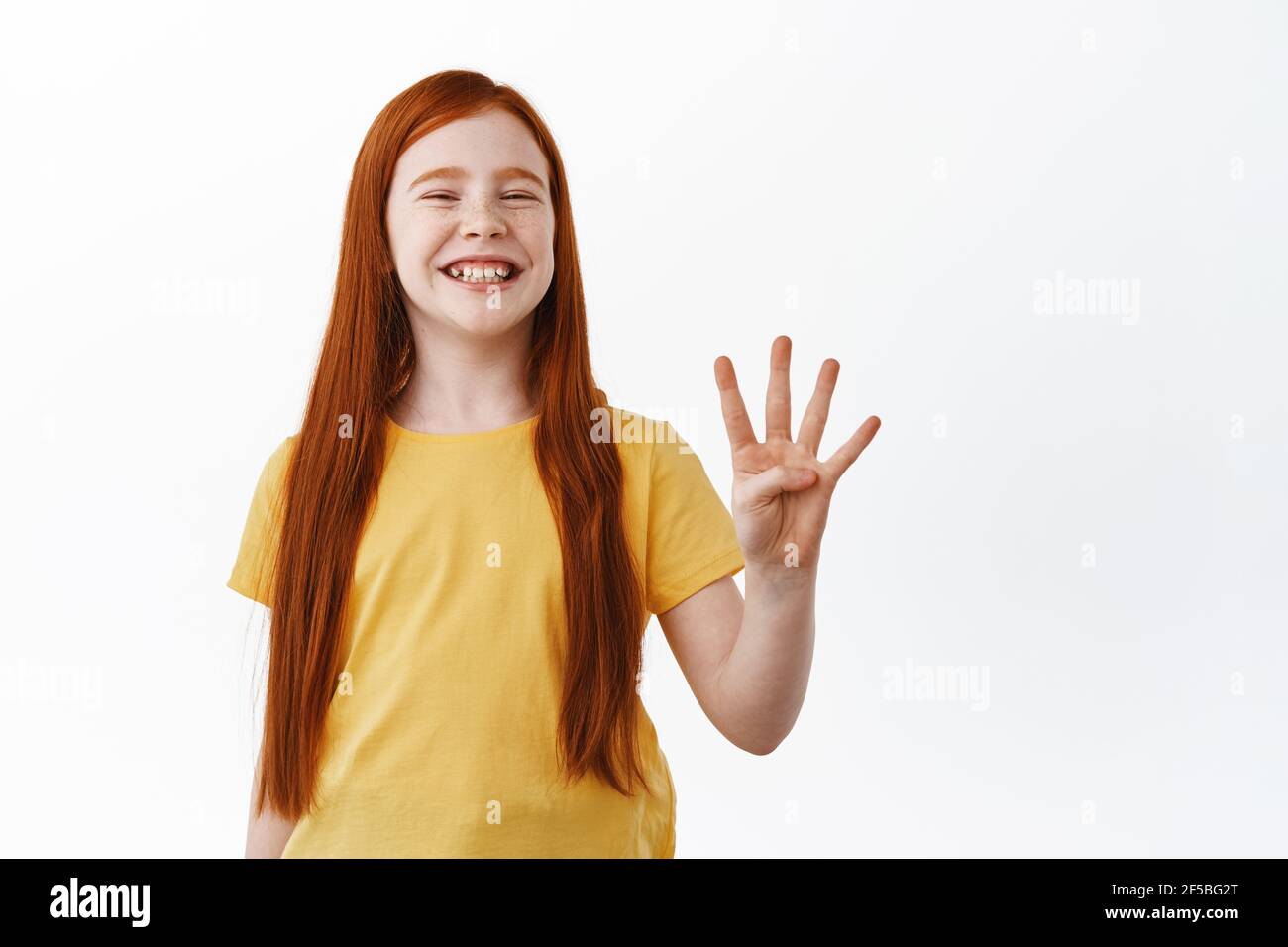 Positive little ginger girl, red head kid with freckles smiling happy ...