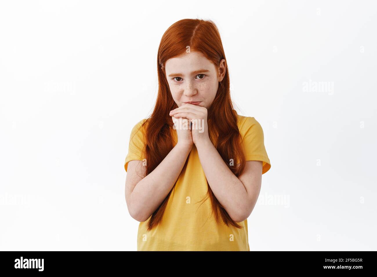 Cute coy redhead girl with freckles begging for something, say please ...