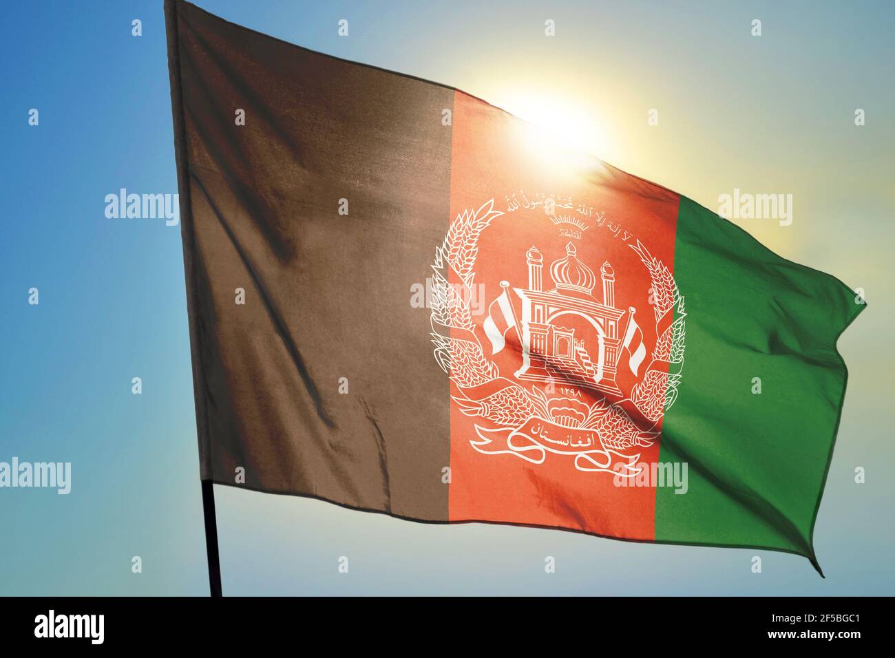 Afghanistan flag waving on the wind in front of sun Stock Photo - Alamy