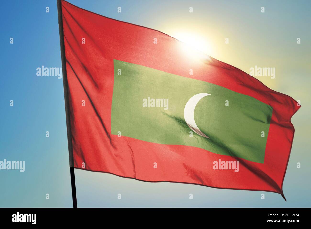 Maldives flag waving on the wind in front of sun Stock Photo - Alamy