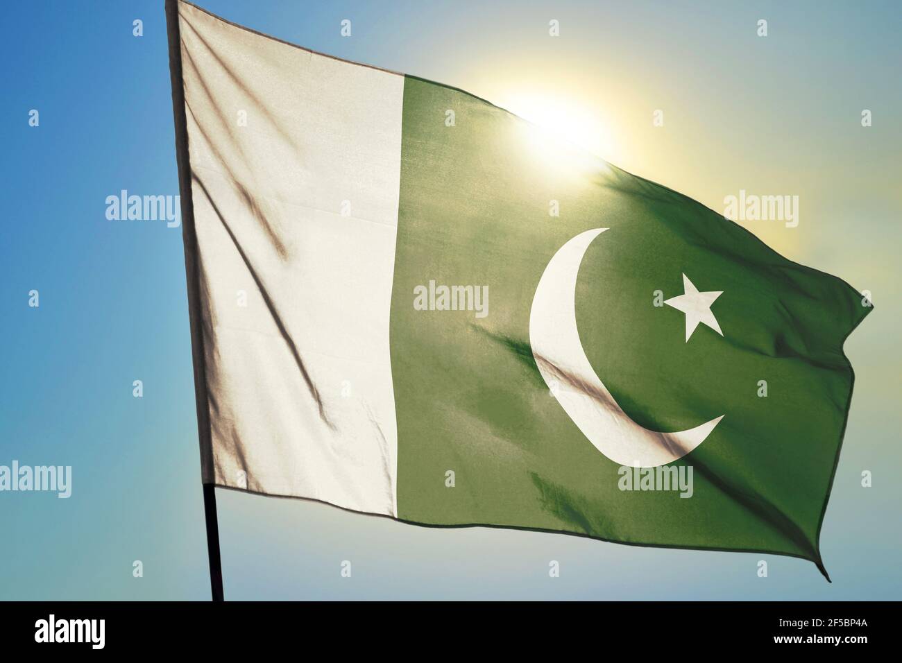 Pakistan flag waving on the wind in front of sun Stock Photo - Alamy