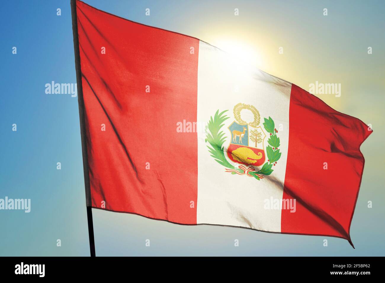 Peru flag waving on the wind in front of sun Stock Photo - Alamy