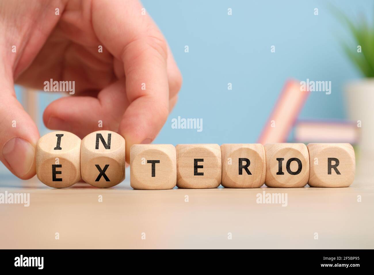 Choosing concept antonyms interior and exterior on wooden cubes Stock ...