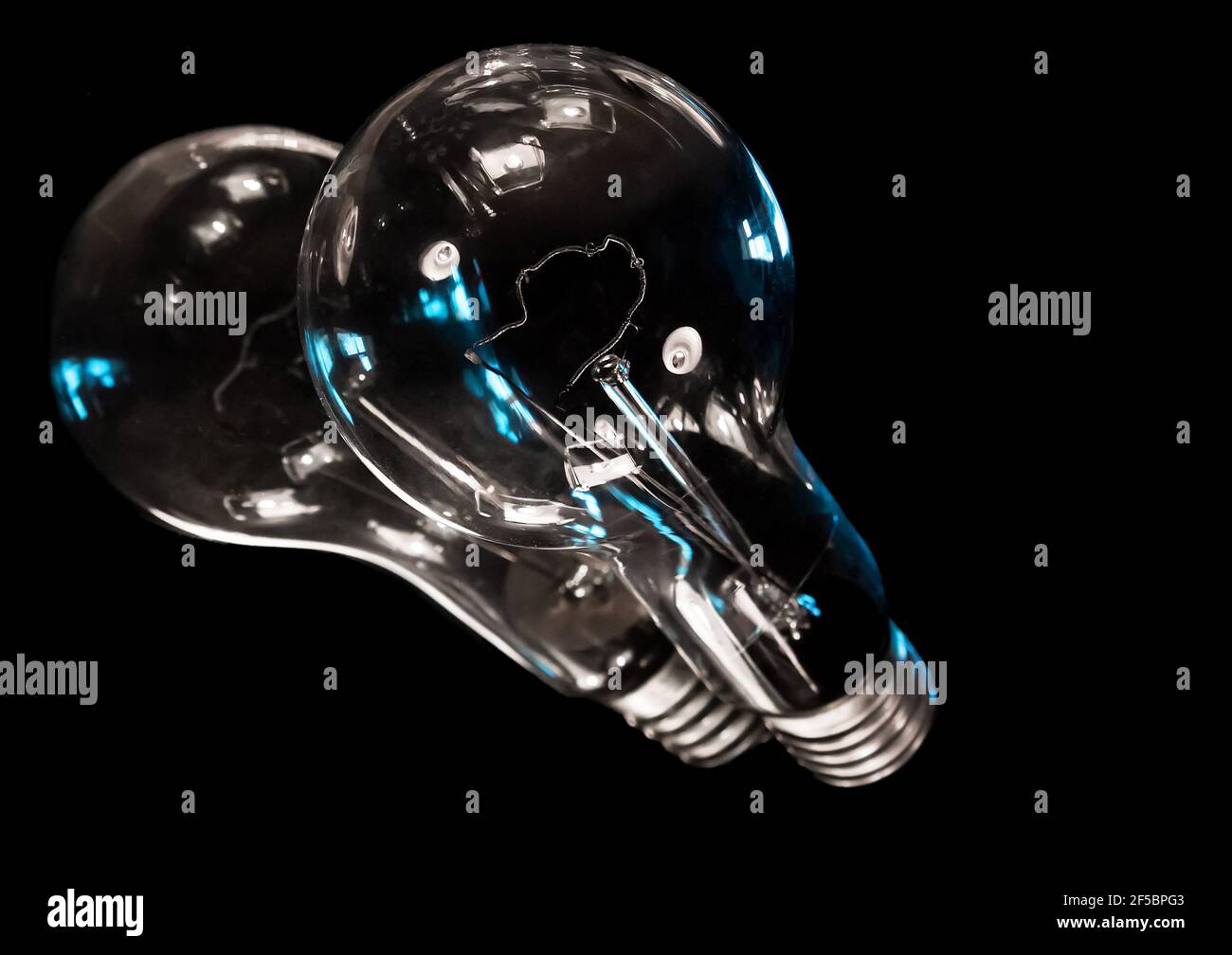 Light bulb with reflection and glare on a black background, isolated ...