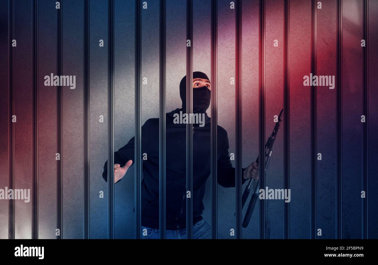 Thief with balaclava was captured and closed in a prison by police ...