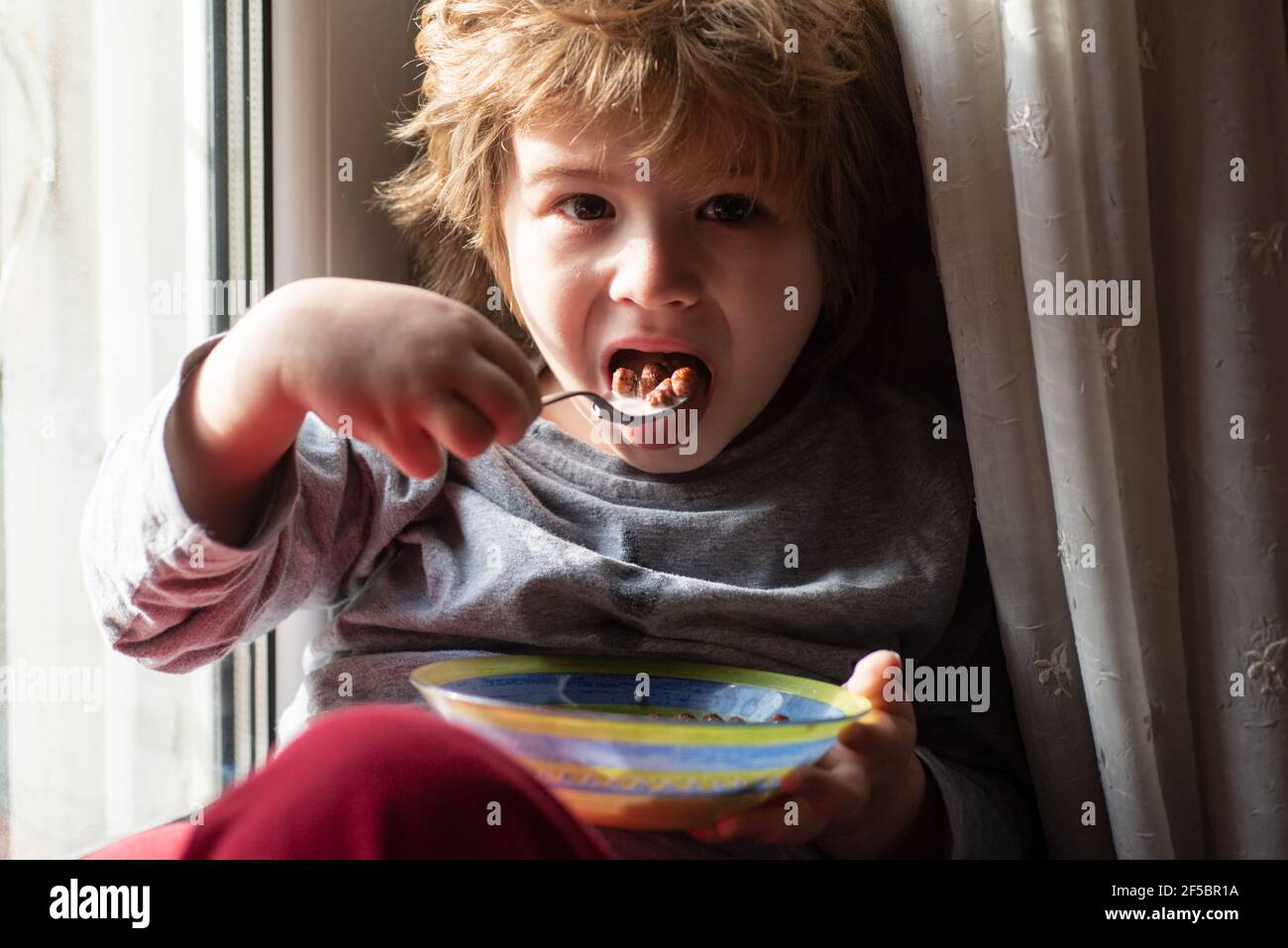 Hungry kid eat. Child eating healthy food. Cute little boy having soup ...