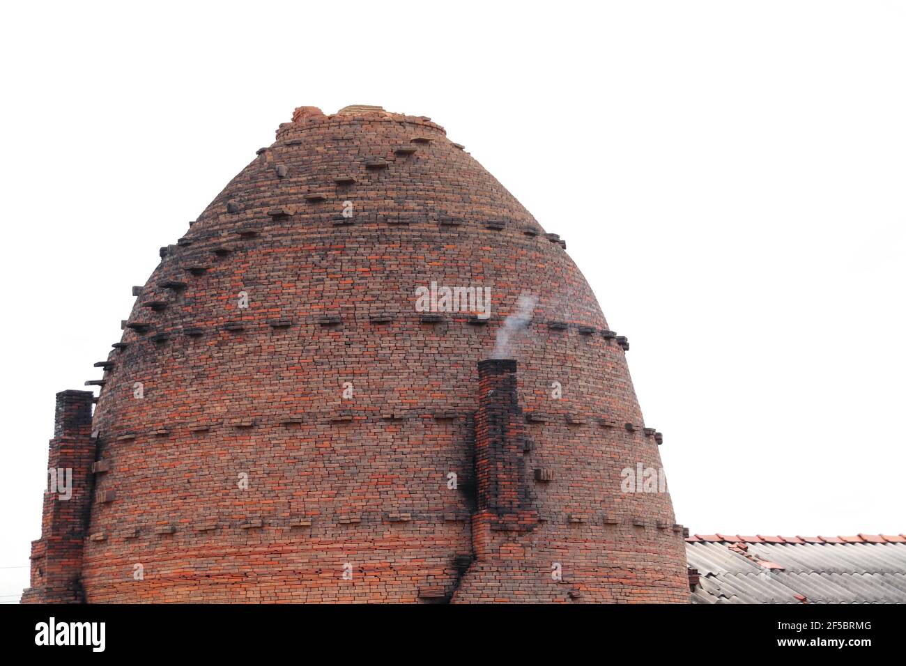 Historical red brick tower with the smoke rising from the chimney Stock ...