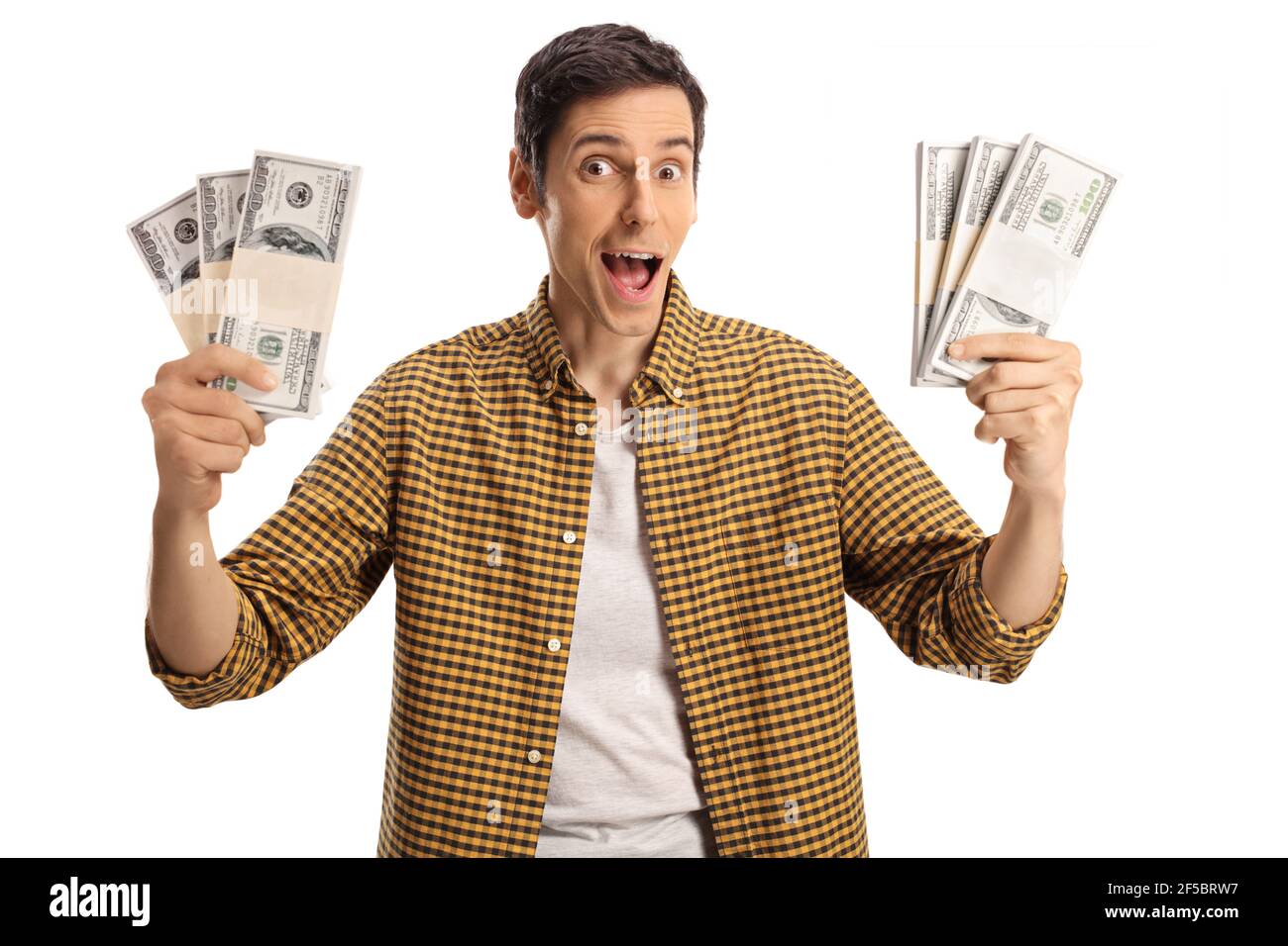 Excited young man holding cash money isolated on white background Stock ...