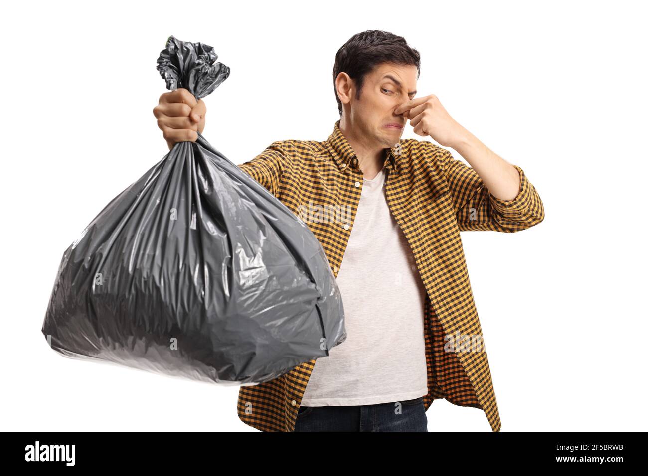 Young man holding a smelly bin bag isolated on white background Stock ...