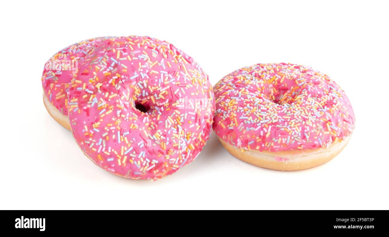 Three pink donuts with small candies on a white background Stock Photo ...
