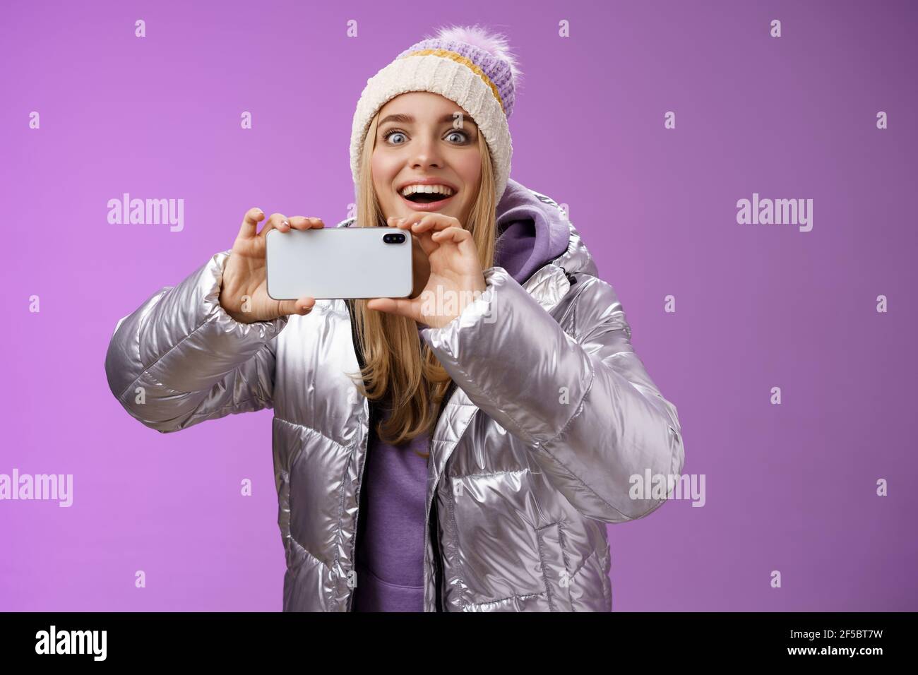 Amused fascinated female in silver jacket head smiling astonished ...