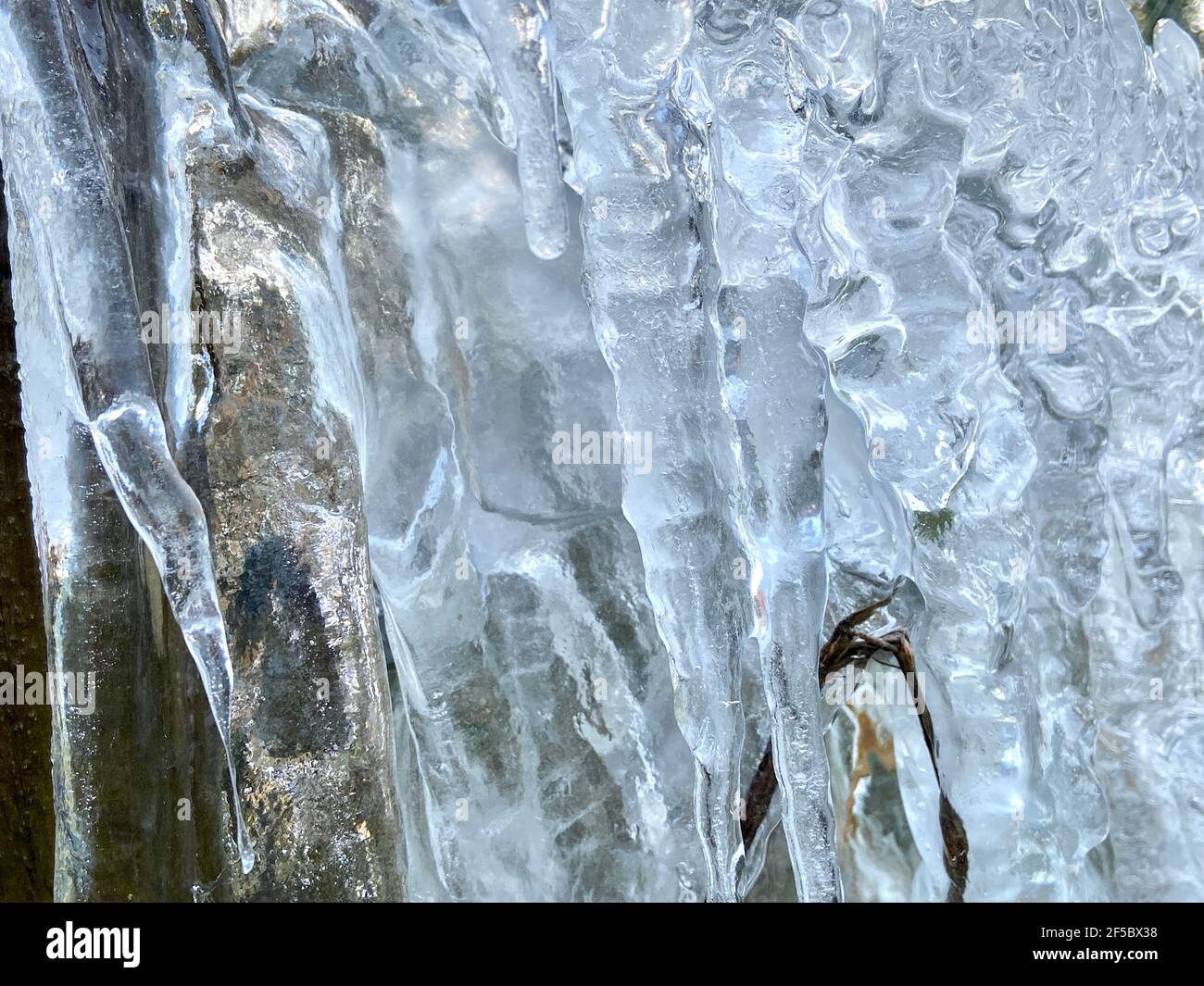 Ice icicle background backdrop with copy space frozen water from tap ...