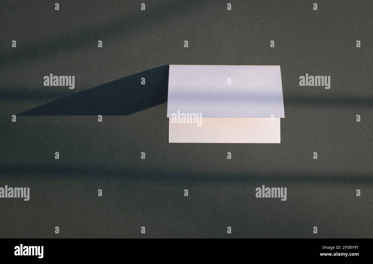 Empty white card with shadows on black background. Copy space Stock ...