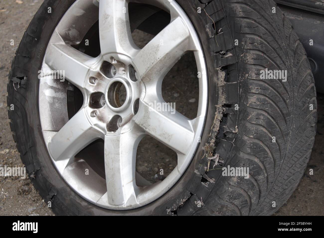 Closeup of a badly damaged car tire on the ground at daytime Stock ...