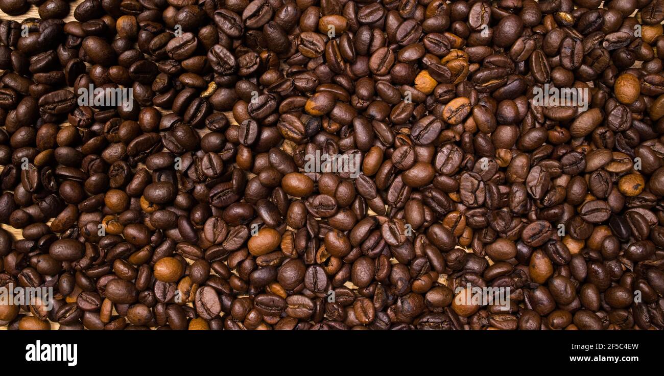 Coffee beans as background picture - top down view Stock Photo - Alamy