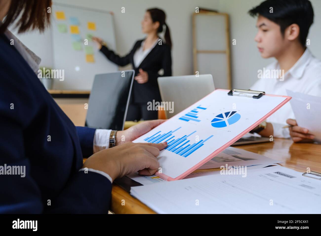 Young accountant marketing team consultants and analyze sales growth in ...