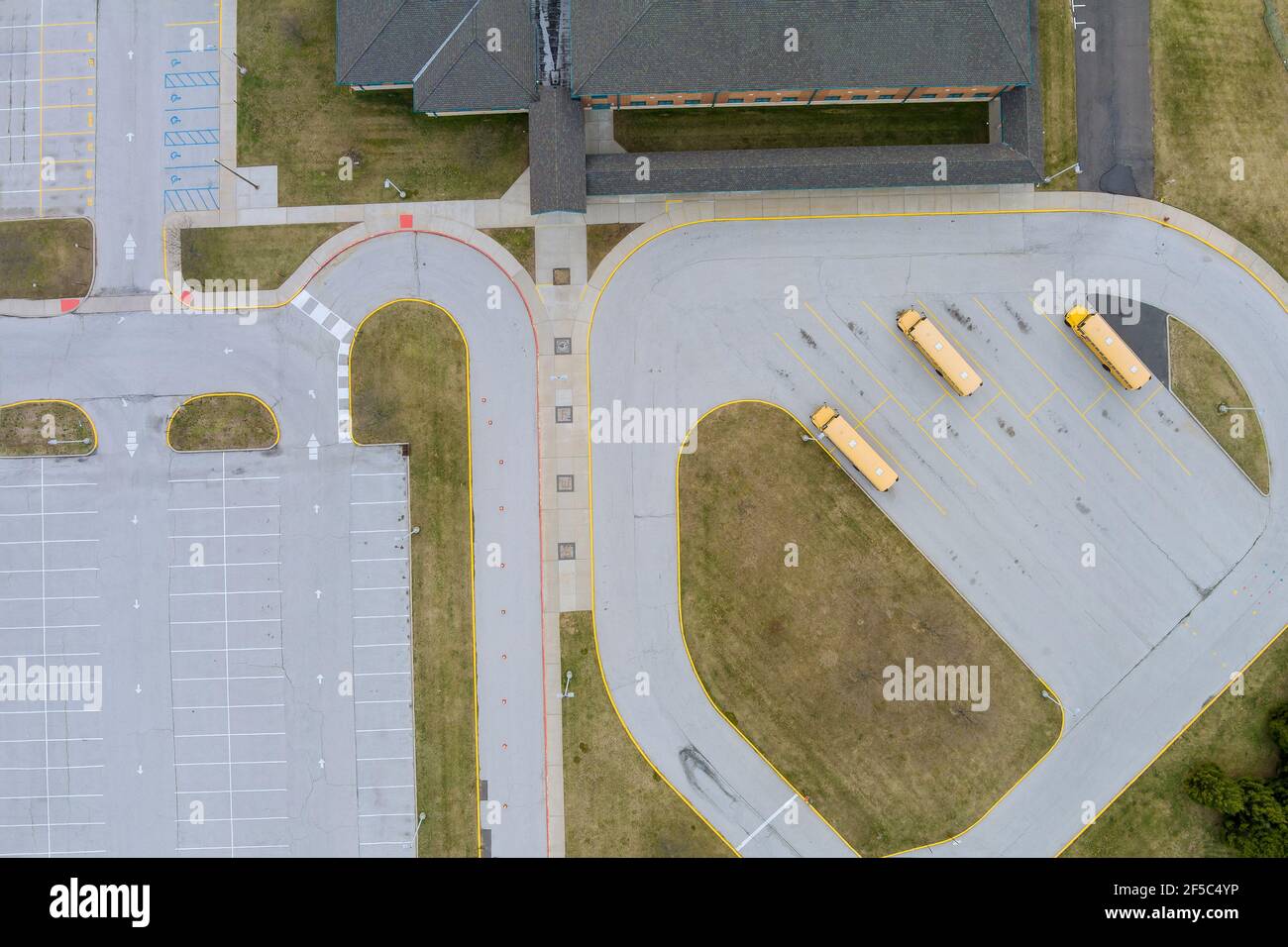 Aerial top view the yellow school buses parked near the high school ...
