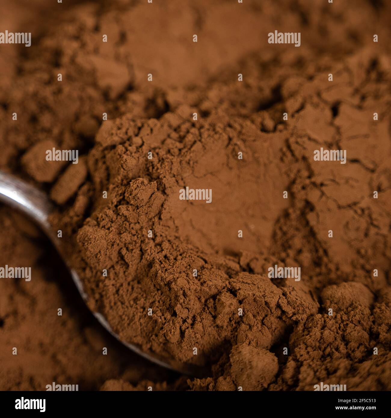 Closeup shot of a spoon scooping cocoa powder Stock Photo - Alamy