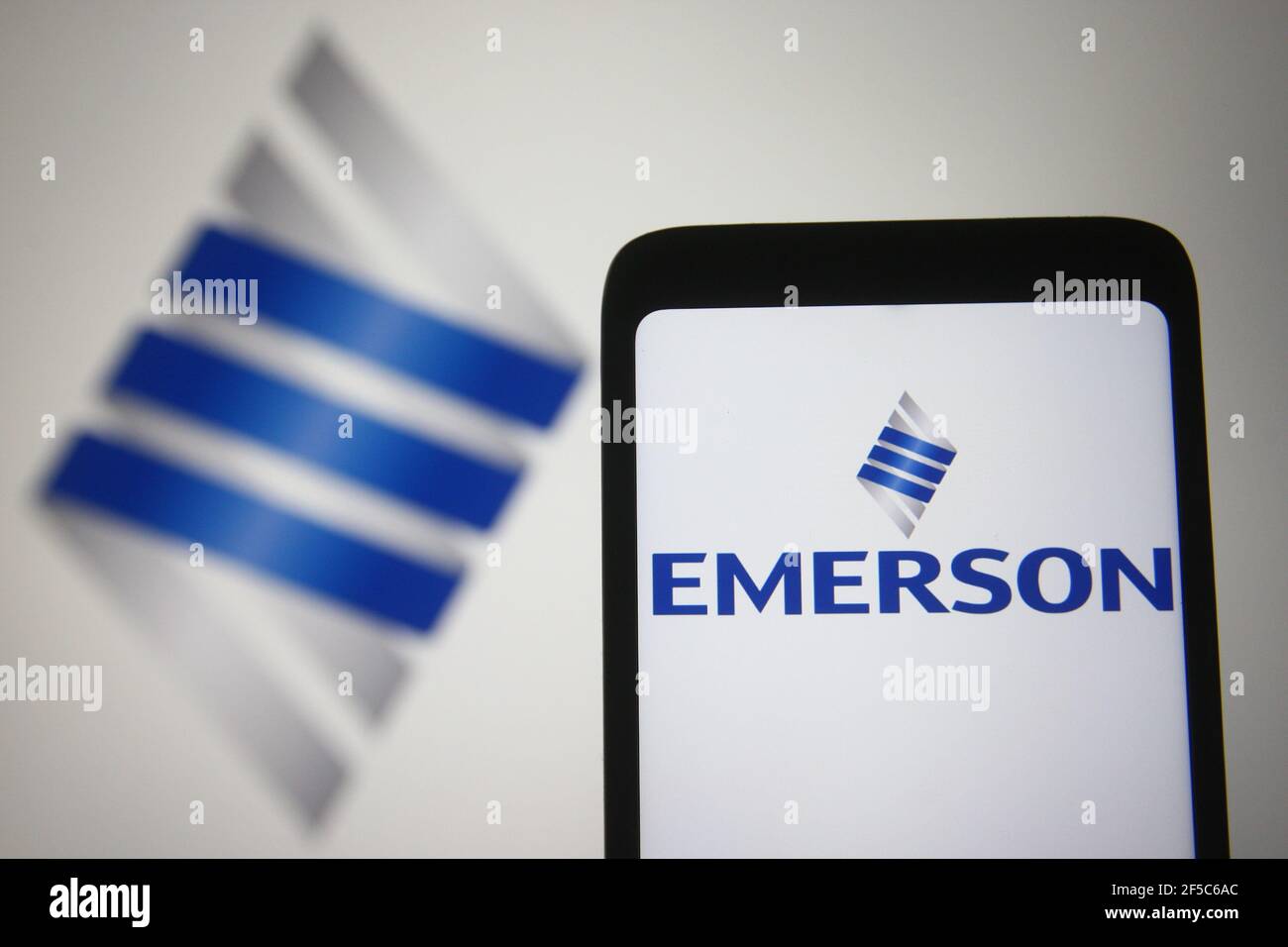 In this photo illustration the Emerson Electric logo is seen on a ...