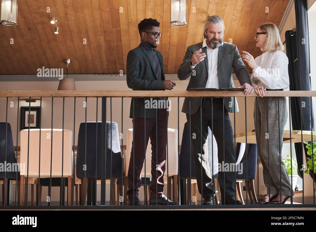 Mature businessman talking to his team and giving a recommendation ...