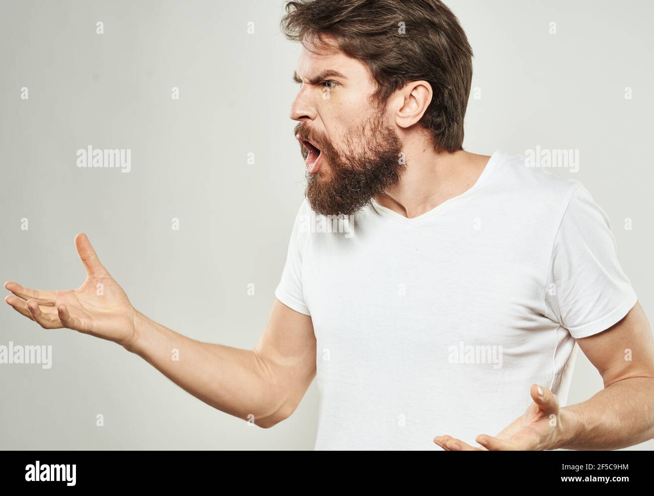Aggressive man gestures with his hands thick beard irritability stress ...