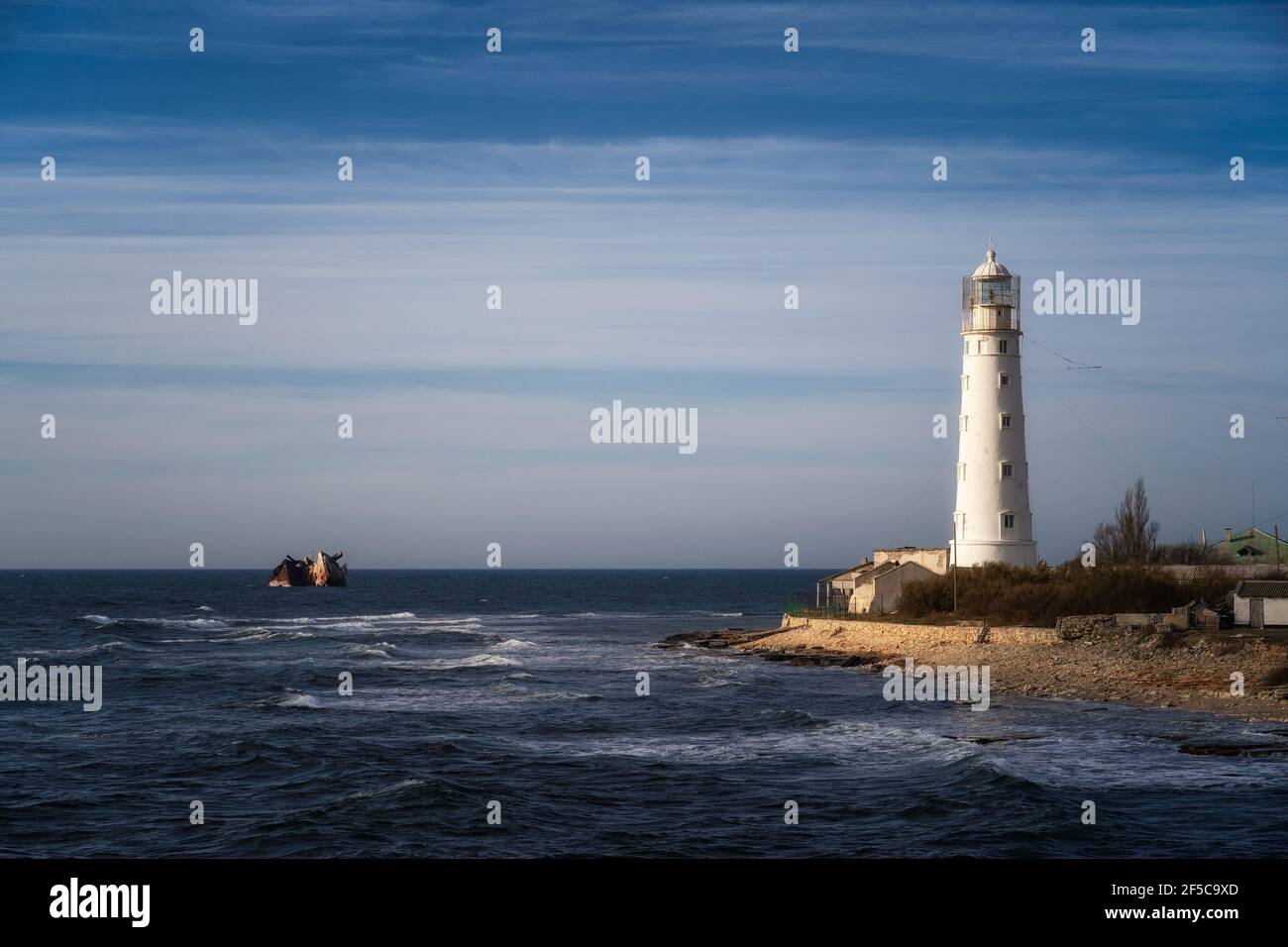 Lone beacon guards the ships. The lighthouse shows the way for boats ...