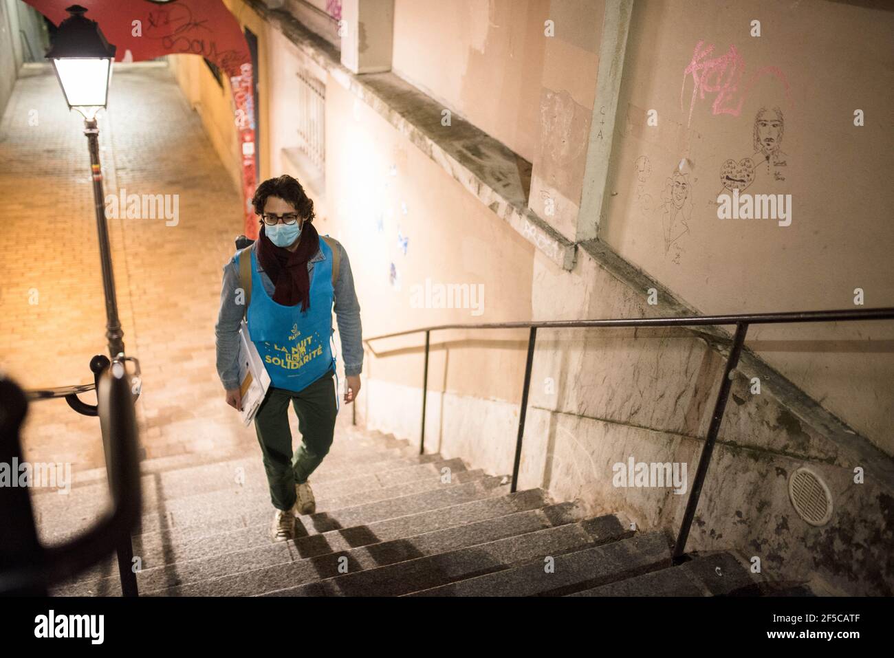 A volunteer walks during the night of solidarity (nuit des solidarites ...