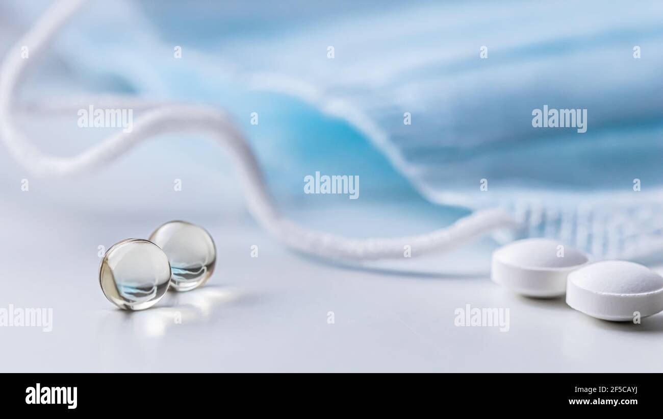 Capsules, pills and medical masks on a white background. Health care ...