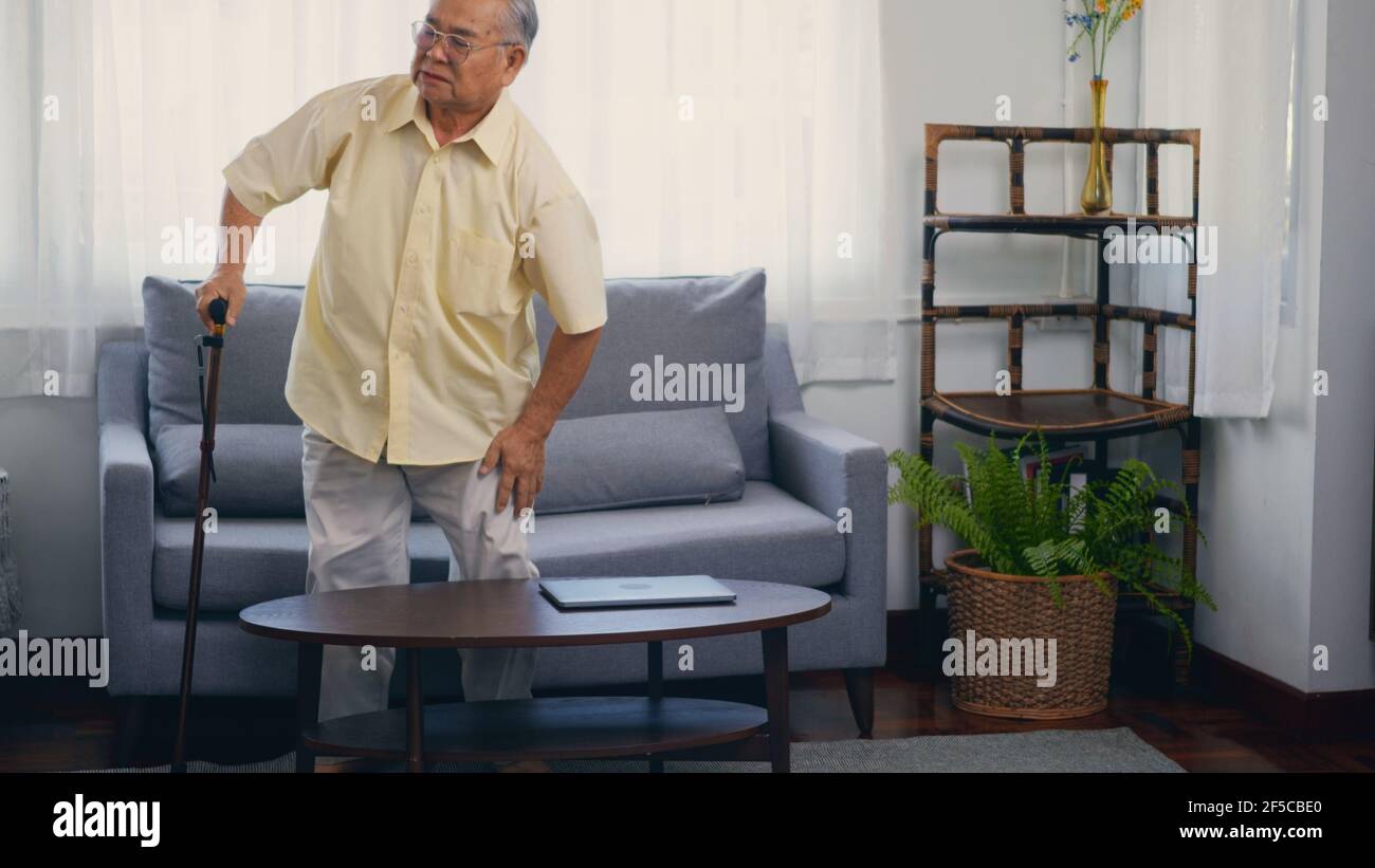 Old man grandfather with eyeglasses used a walking stick to lean the ...